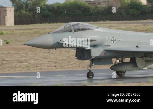 Modern fighter jet taxiing on runway with cockpit visible during ...