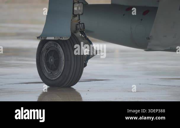 Detailed view of aircraft landing gear strut and wheel during servicing ...