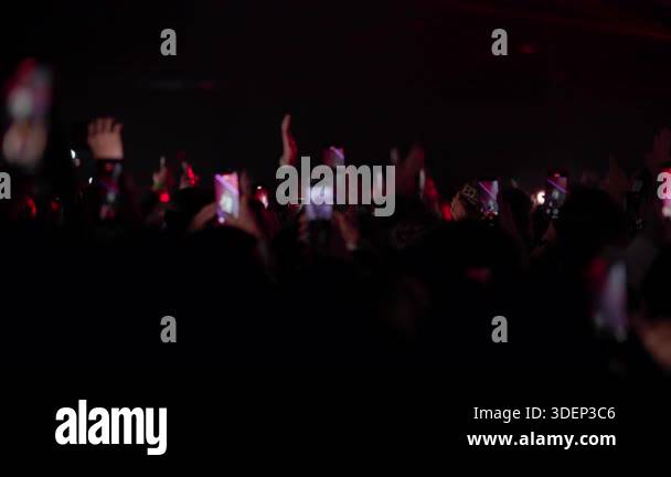 Audience members record live music performance on smartphones while ...