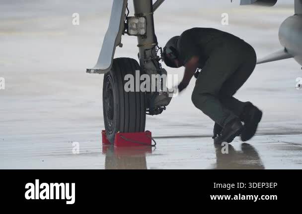 LUQA, MALTA - SEPTEMBER 28, 2025: A military technician kneels beside ...