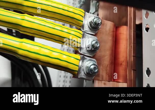 Grounding cables connected to copper busbar with bolts in electrical ...