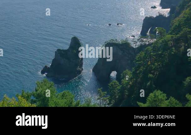 Stunning aerial footage of natural rock arches and rugged sea stacks ...