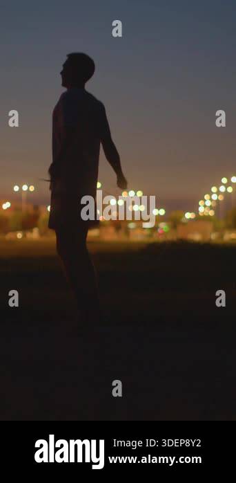 Evening park silhouette man cooling down after jump rope session, soft ...