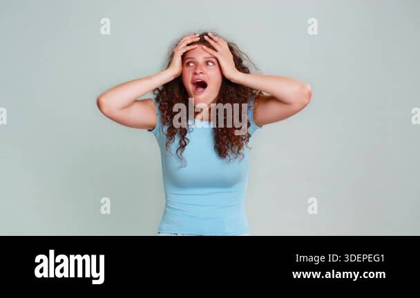 Young woman happily celebrating victory after winning game or receiving ...