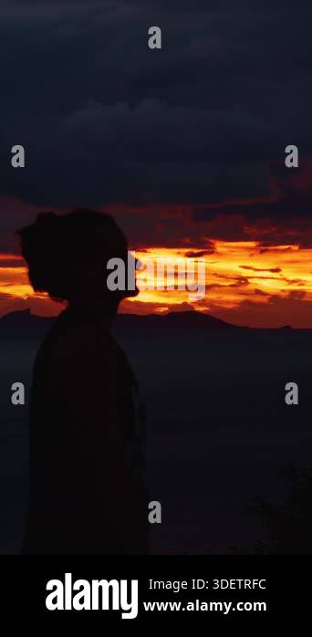 Vertical video. Man Approaches and Kisses Woman as They Stand in ...