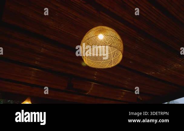 Warm Light from Woven Bamboo Lamp Hanging under Wooden Ceiling in ...
