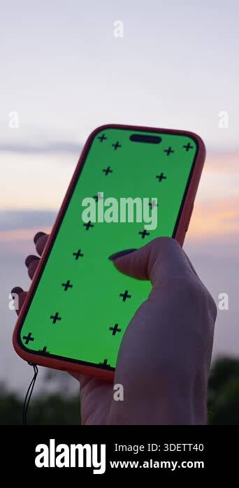 Vertical video. Female Hand Holding Smartphone with Green Screen over ...