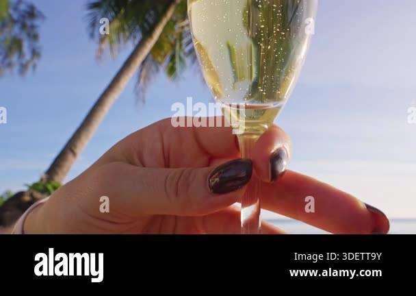 Hand Holding Glass of Champagne with Bright Sunlight Reflected on ...