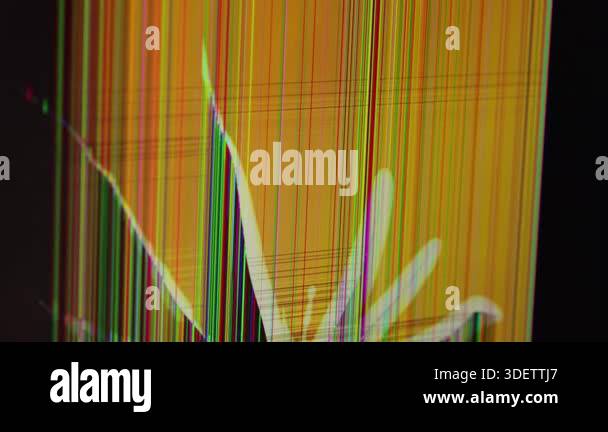 A close-up of a shattered laptop screen reveals damaged pixels and ...
