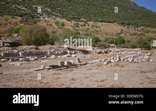 Ancient ephesus ruins with scattered marble blocks and low hillside ...