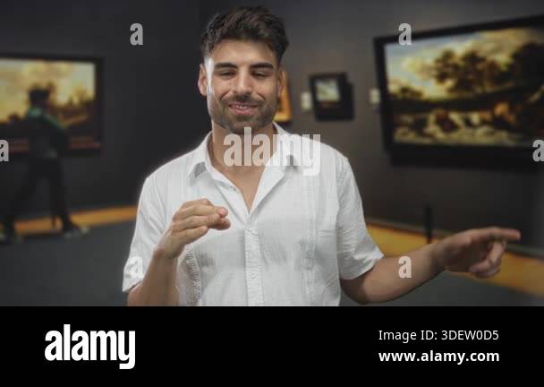 Man hand forming ok sign gesture while pointing finger at painting in ...