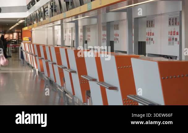 Row of empty check-in desks at Warsaw Chopin Airport terminal. Unmanned ...
