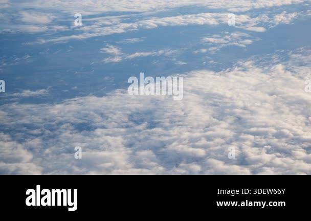 High altitude aerial view tilting up from visible ground landscape with ...