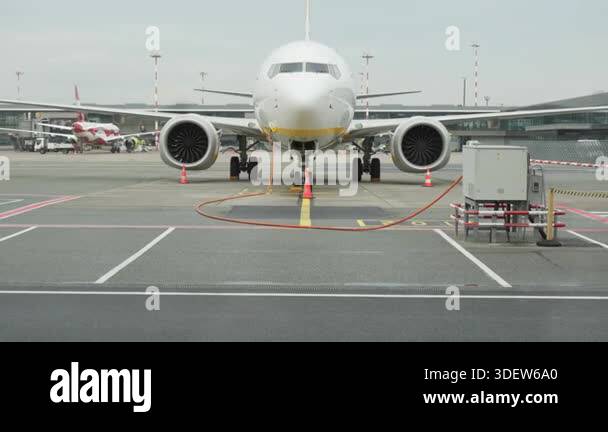 Head-on view of passenger aircraft receiving electricity via orange GPU ...