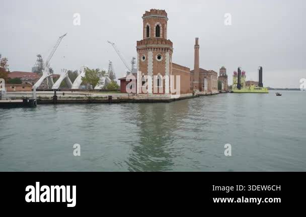 Giant white hand sculptures and historical Arsenale towers in Venice ...