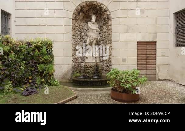 Neptune fountain statue with trident in stone grotto niche inside ...