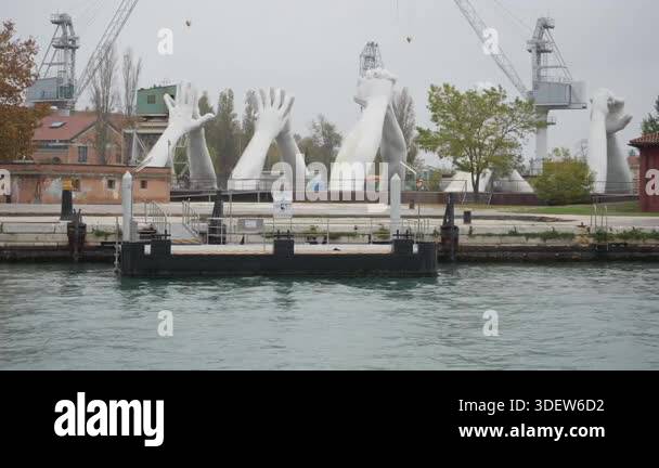 VENICE, ITALY - NOVEMBER 03, 2025: Lorenzo Quinn Building Bridges art ...