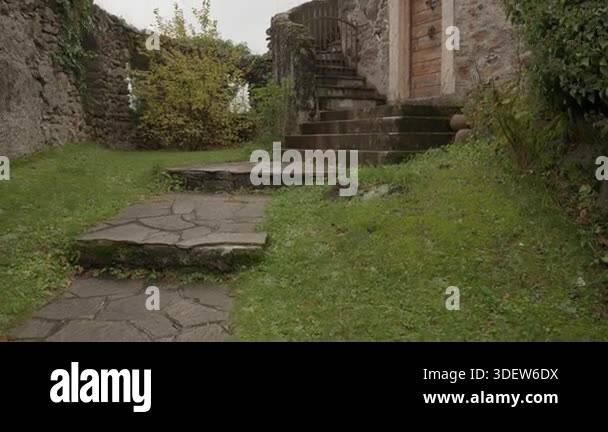 Stone steps and path lead to a weathered wooden door in ancient ...