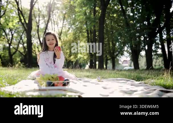Cute little girl eating red apple. Kid eating fruit. Child bites fruit ...