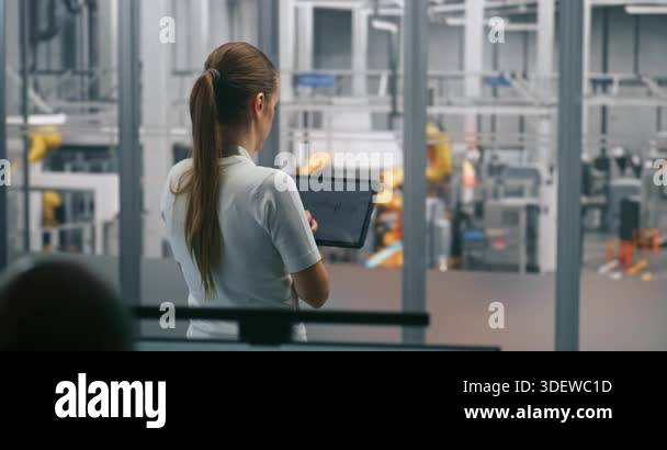 Female Engineer Managing Production Via Tablet. Woman Standing and ...