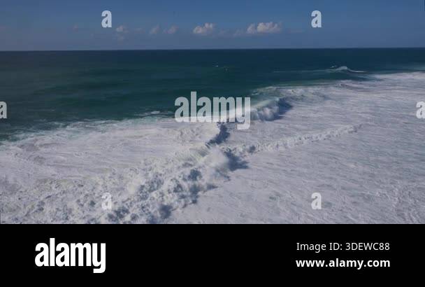 An aerial view captures the powerful dynamism of deep blue ocean water ...