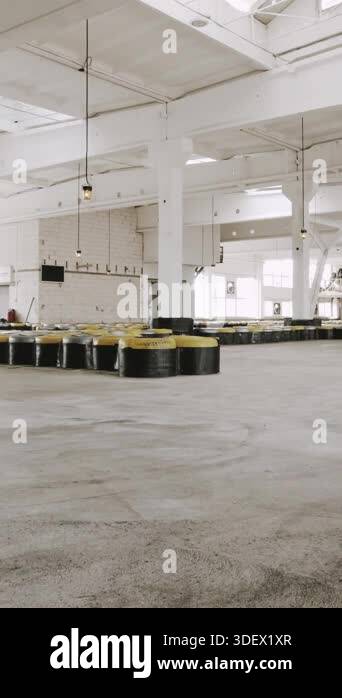 Indoor vertical view go-kart racing circuit with empty track, safety ...