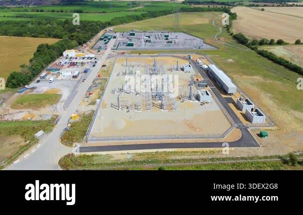 Aerial drone shot of electrical sub station, powerlines, pylons and ...