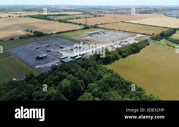 Aerial drone shot of electrical sub station, powerlines, pylons and ...