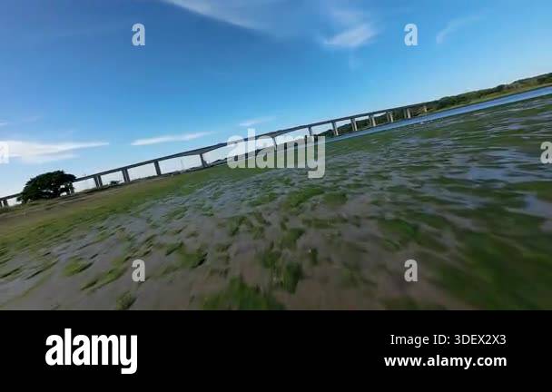 FPV drone low pass aerial view of Orwell Bridge and estuary wetland ...