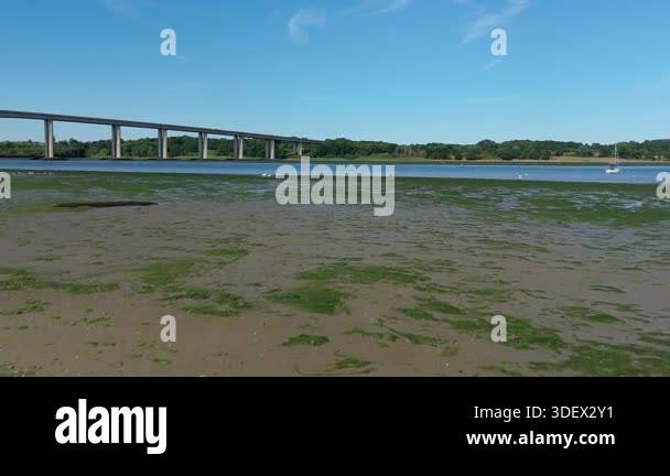 FPV drone low pass aerial view of Orwell Bridge and estuary wetland ...