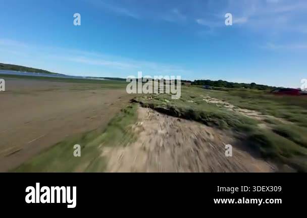 FPV drone low pass aerial view of Orwell Bridge and estuary wetland ...