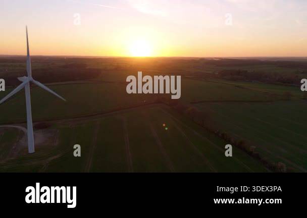 Aerial view of wind turbines at sunset. Golden light and rural ...