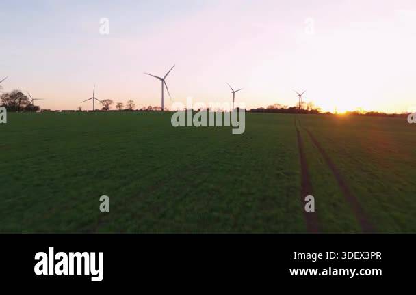 Aerial view of wind turbines at sunset. Golden light and rural ...