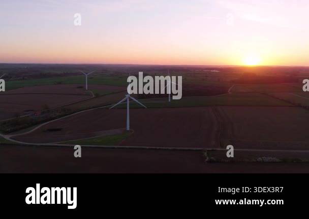 Aerial view of wind turbines at sunset. Golden light and rural ...
