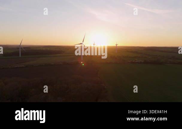 Aerial view of wind turbines at sunset. Golden light and rural ...