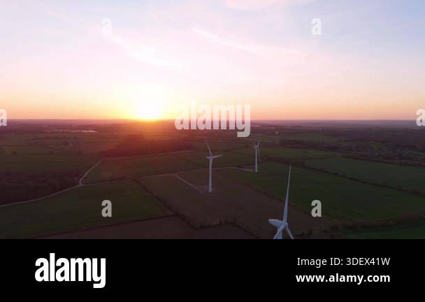 Aerial view of wind turbines at sunset. Golden light and rural ...