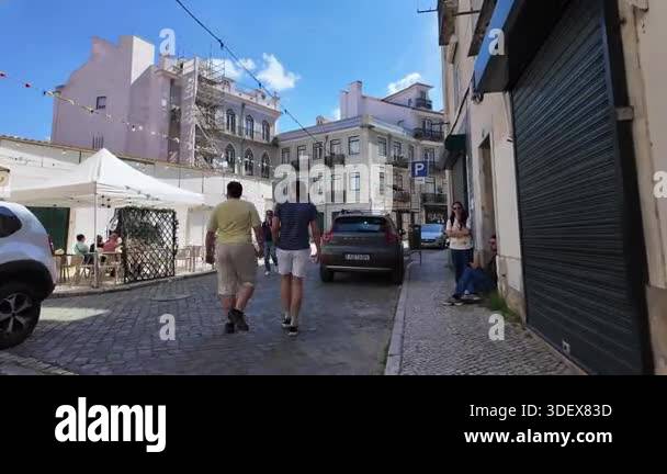 Walking down narrow Lisbon alleyway POV Europe tourism street Stock ...