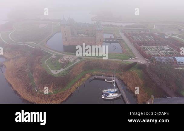 Aerial view of moated Dutch castle cylindrical towers, red shutters ...