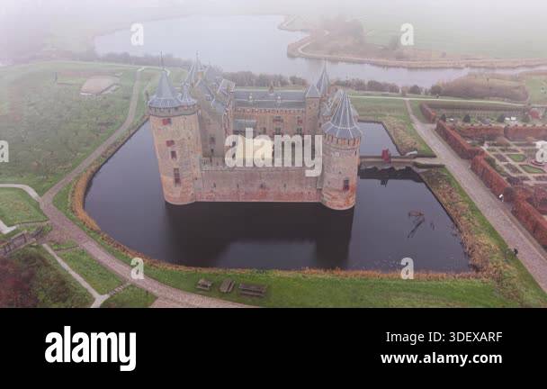 Aerial view of moated Dutch castle cylindrical towers, red shutters ...