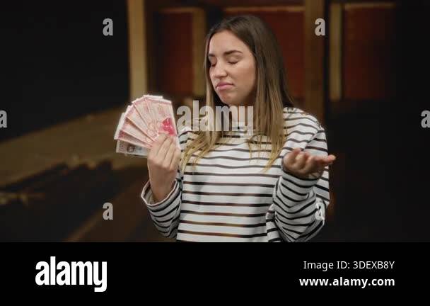 Woman holding icelandic krona banknotes at indoor construction site ...