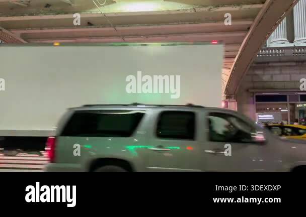 night terminal entrance with trucks, taxis blurred headlights and ...
