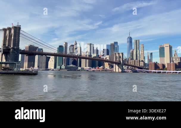 Cityscape with river, Urban skyline beside flowing river, Sunlit glass ...