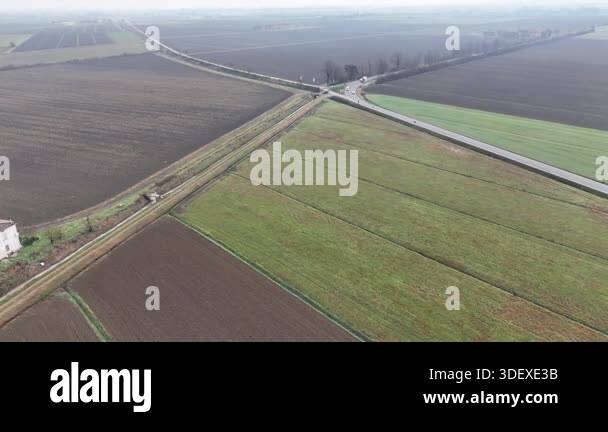 An aerial perspective captures a junction of rural roads amidst vast ...