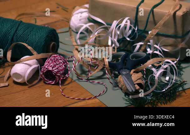 Christmas gift with wrapping ribbon and string green background medium ...