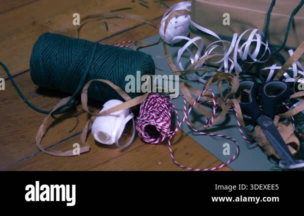 Christmas gift with wrapping ribbon and string green background medium ...