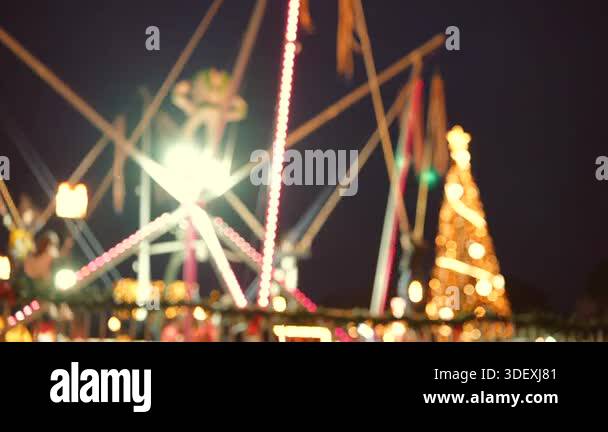 crowd watching acrobatic bungee performers under sparkling Christmas ...