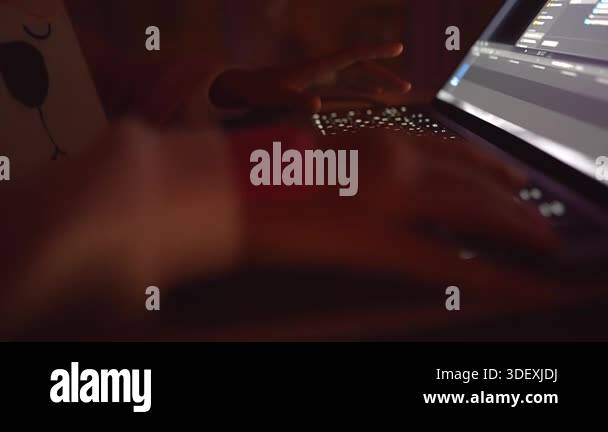 closeup backlit keyboard hands coding on laptop, concentrated typing ...