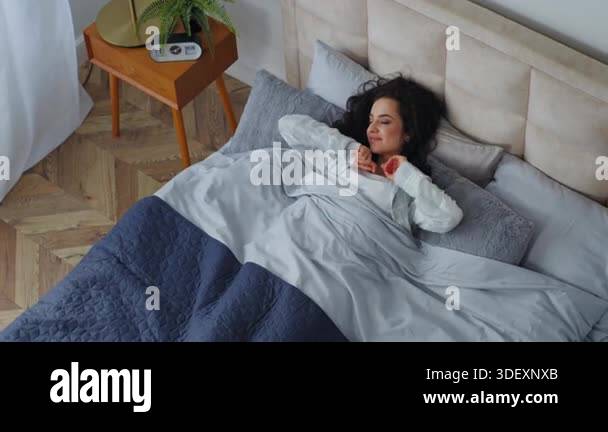 Top view Caucasian smiling happy woman waking up in morning lying in ...