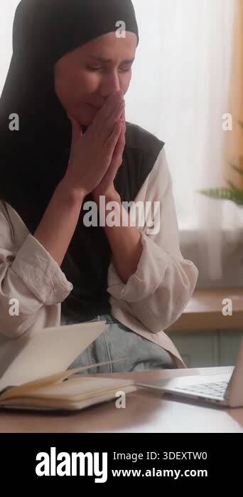 Sad upset Arabian Muslim woman in hijab crying kitchen laptop debt ...