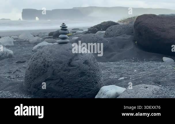 Balanced Stone Cairn on Remote Black Pebble Beach in Iceland. High ...